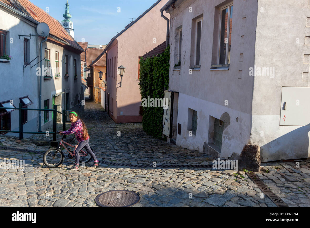 Jewish Quarter, Trebic Czech Republic, a child girl pushing a bike ...