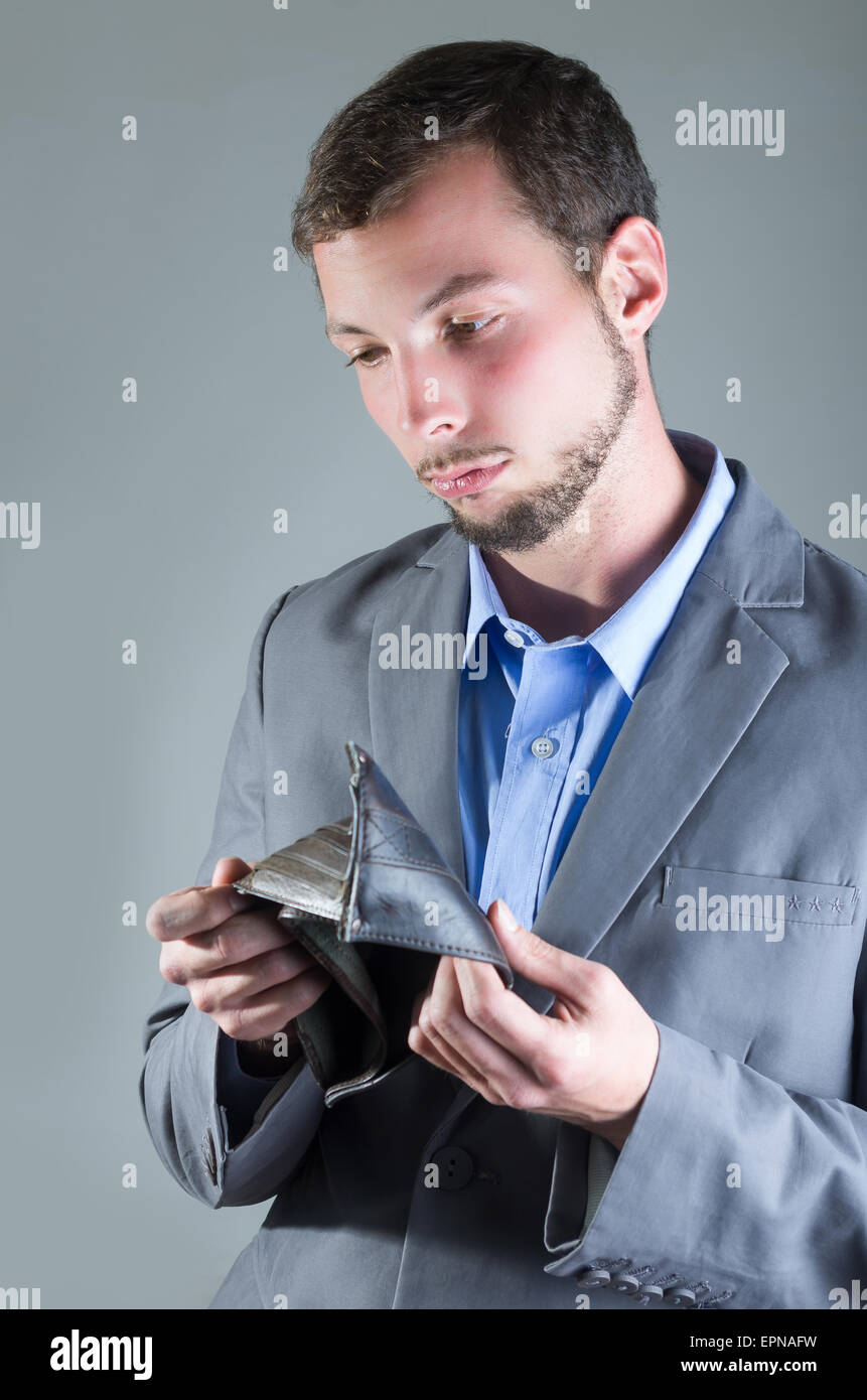 Portrait of young handsome man holding empty wallet Stock Photo - Alamy