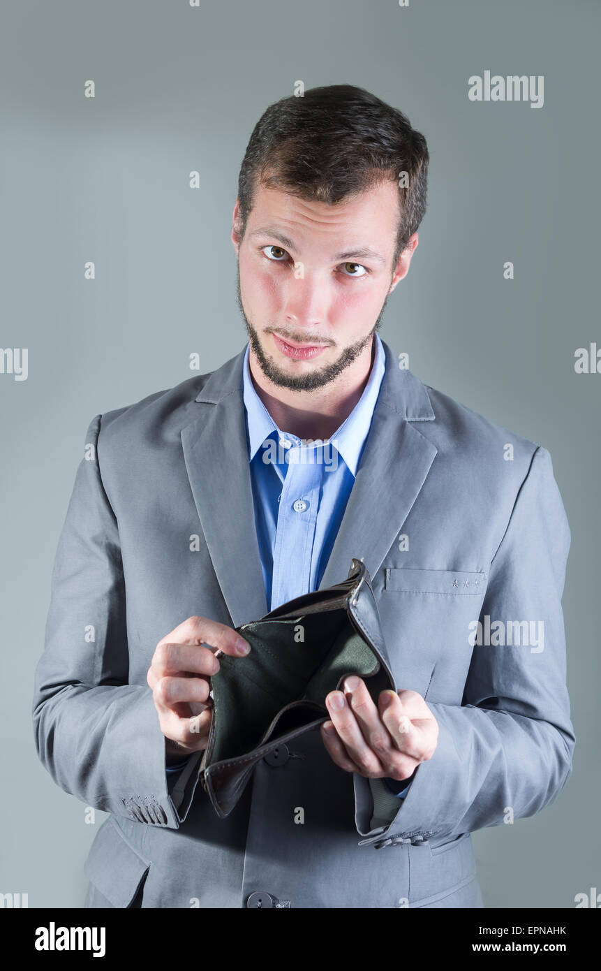 Portrait of young handsome man holding empty wallet Stock Photo - Alamy