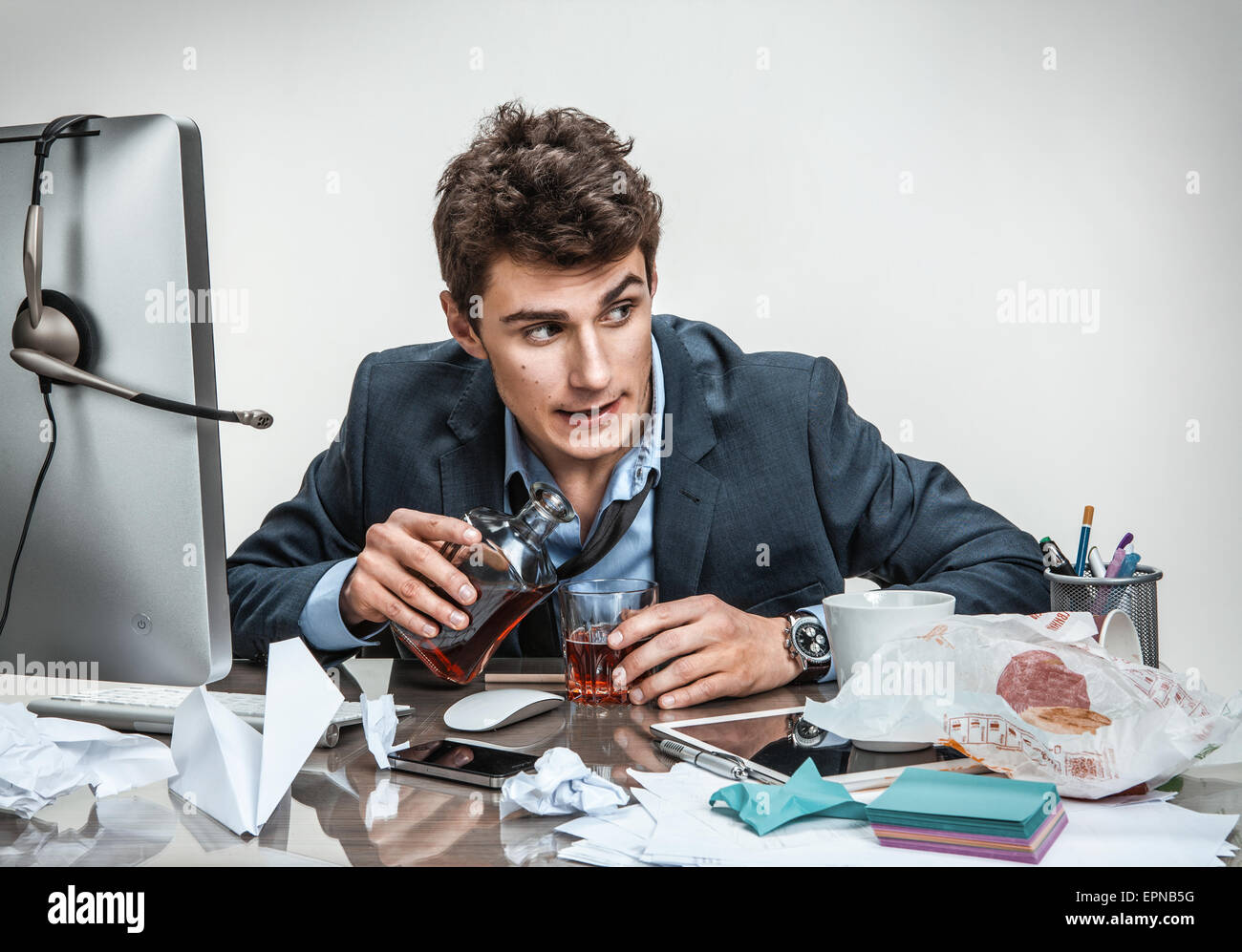 Drunk businessman sitting drunk at office with computer holding glass ...