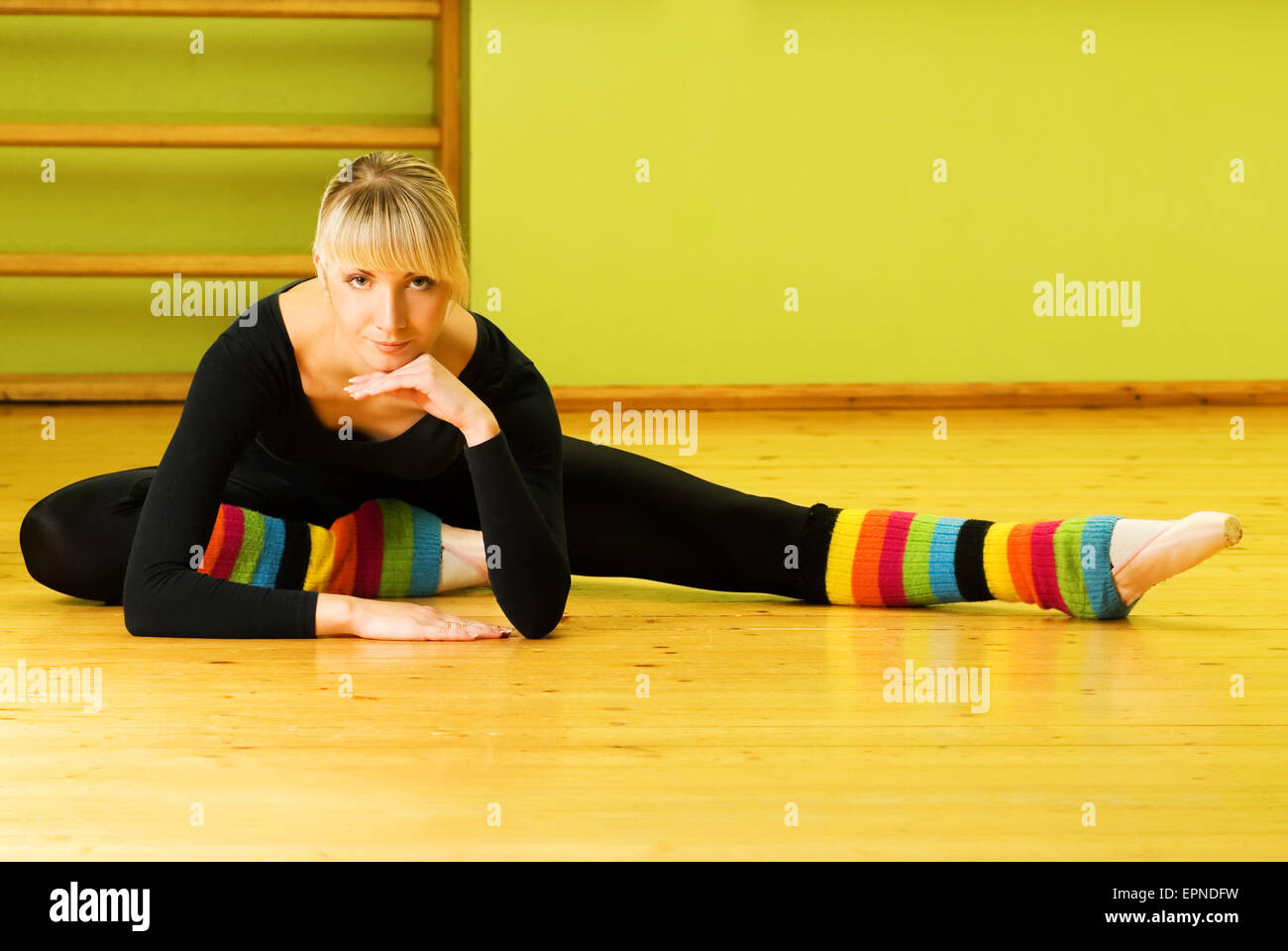 Ballet dancer doing stretching exercise on a floor Stock Photo - Alamy
