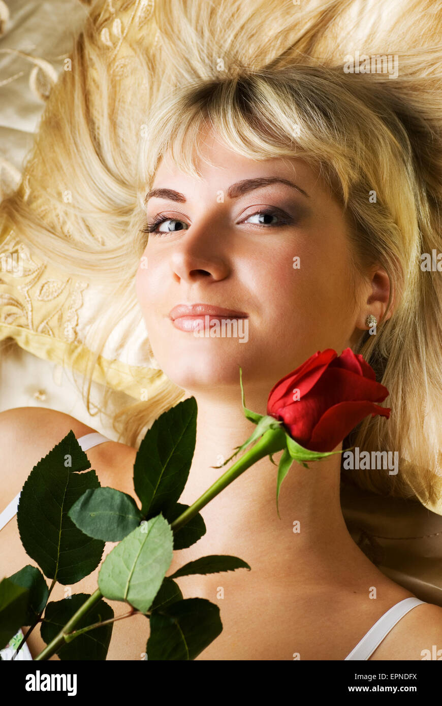 Young beautiful woman with red rose Stock Photo - Alamy