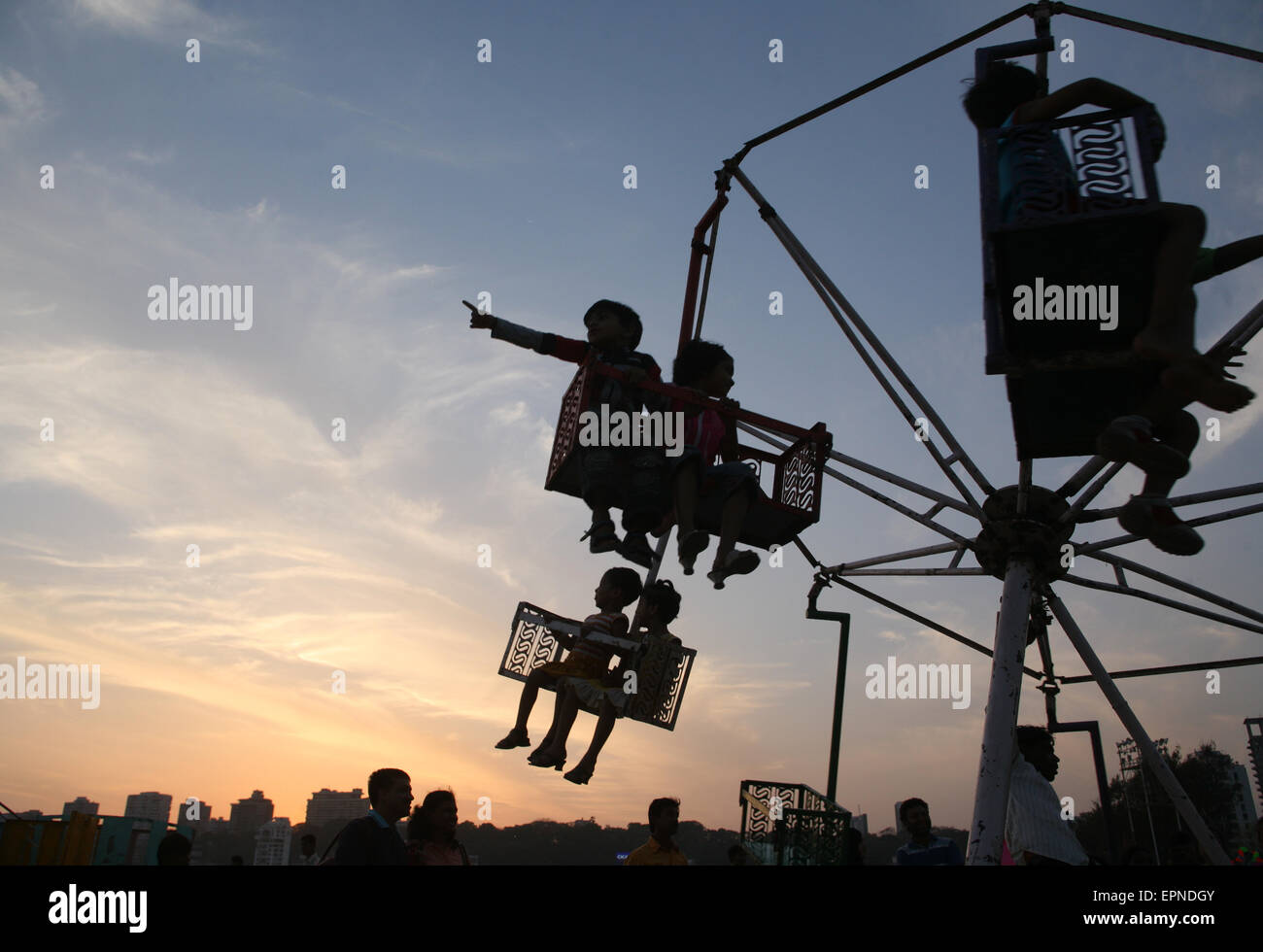 Silhouette children on fairground ride hi-res stock photography and ...