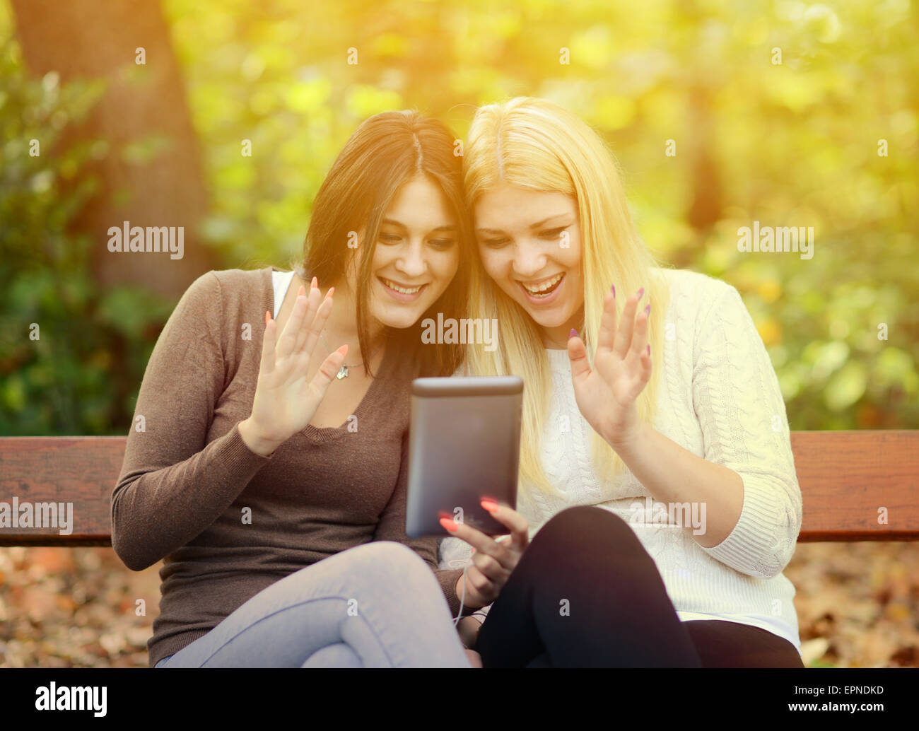 Friends chating with friend outdoor with digital tablet Stock Photo - Alamy