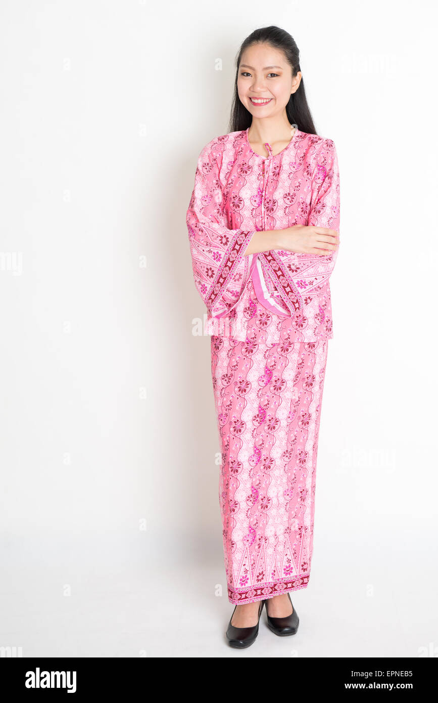 Full Body Portrait Of Happy Southeast Asian Woman In Pink Batik Dress