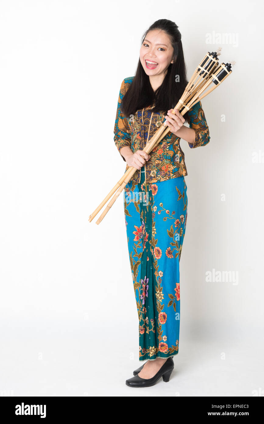 Full Body Portrait Of Southeast Asian Girl In Batik Dress Hands Holding