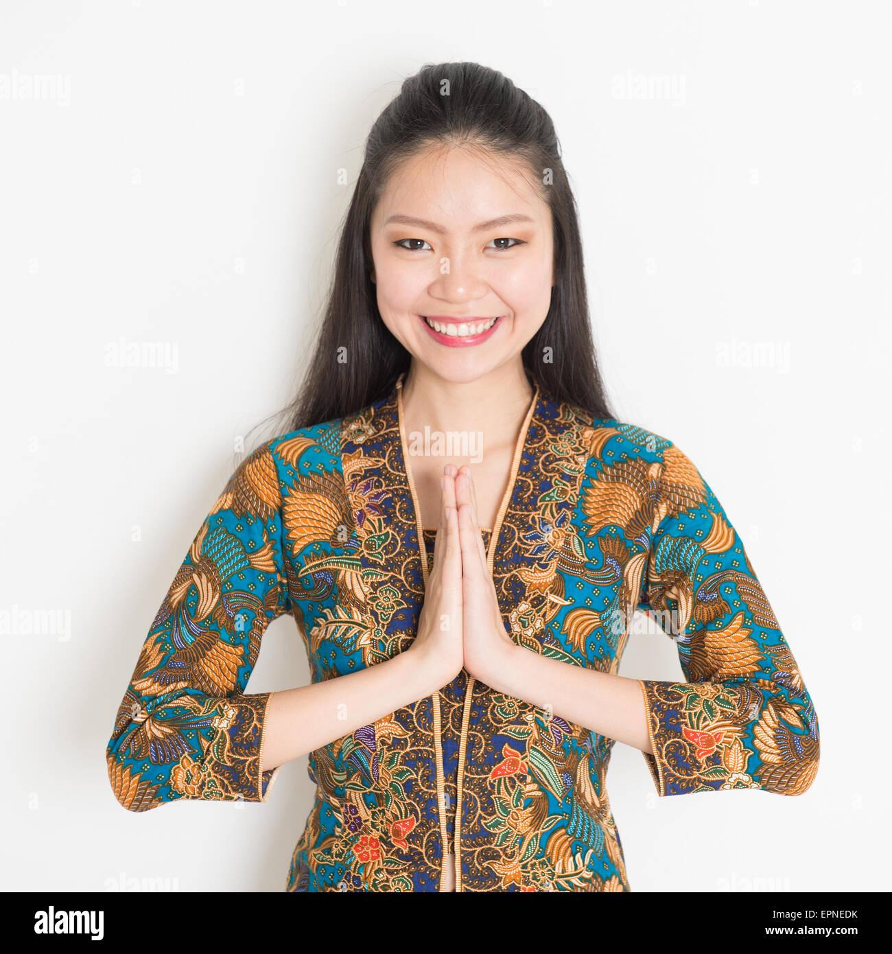 Portrait Of Happy Southeast Asian Woman With Batik Dress In Greeting