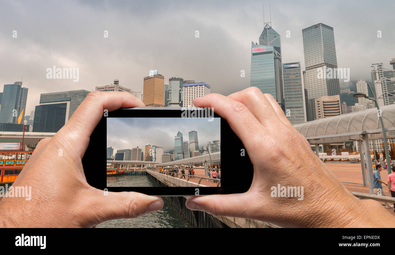 Man and woman hand capturing Hong Kong skyline with smartphone Stock ...