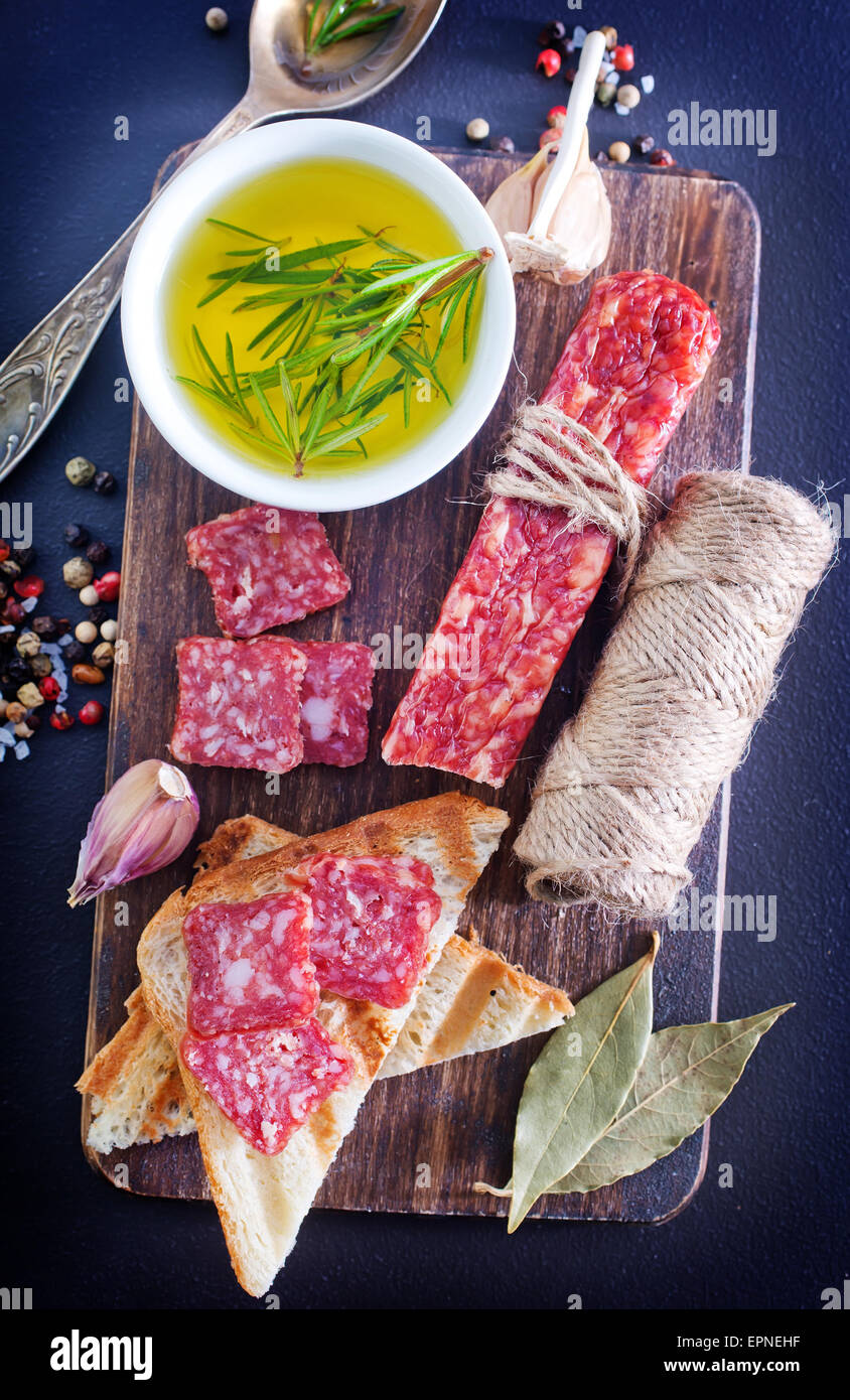 salami and toasts on the wooden board Stock Photo - Alamy