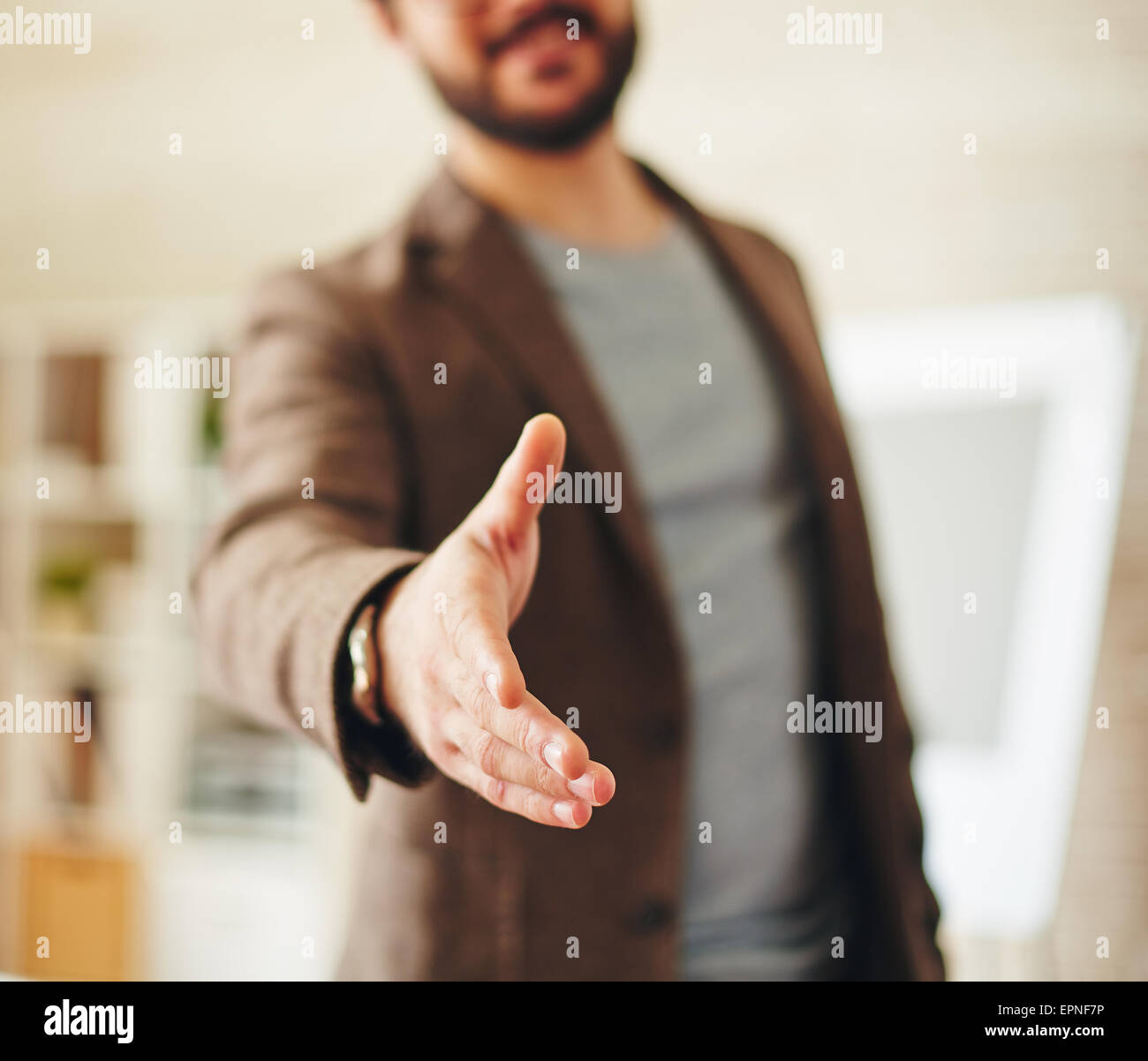 Businessman giving his hand for handshake to partner Stock Photo - Alamy