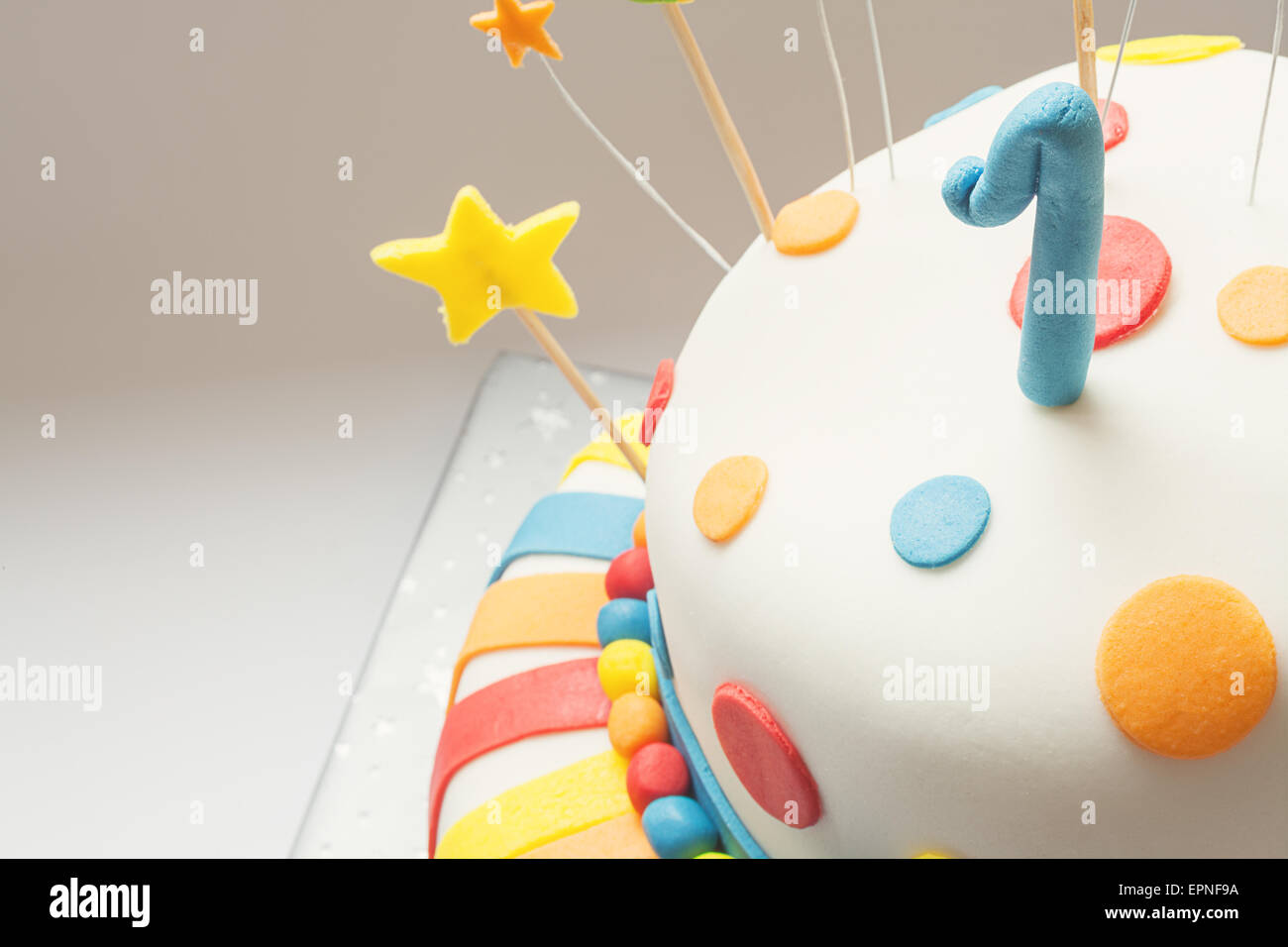 Funny birthday cake with number one on top, sweet colorful decoration ...