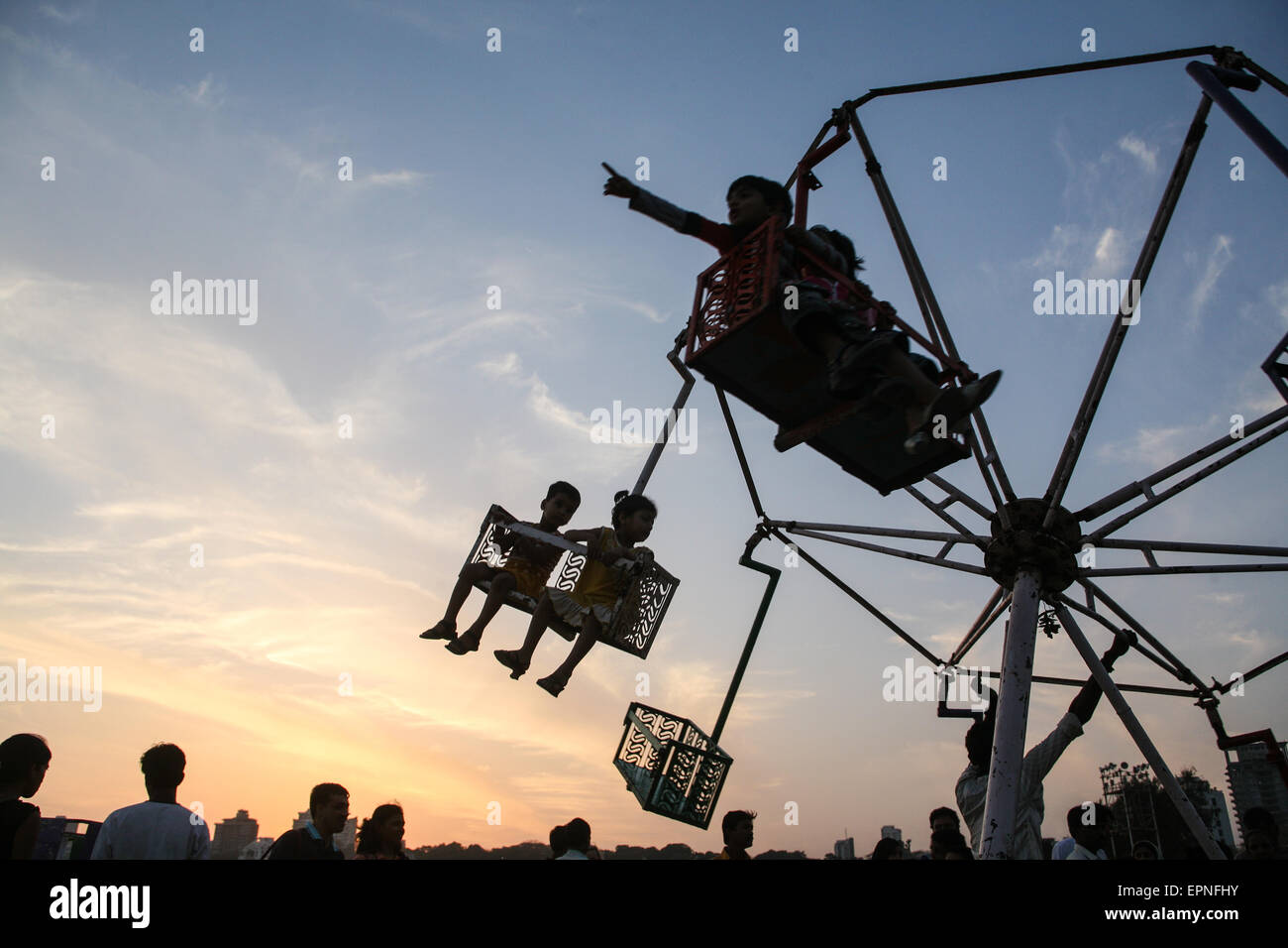 Silhouette children on fairground ride hi-res stock photography and ...