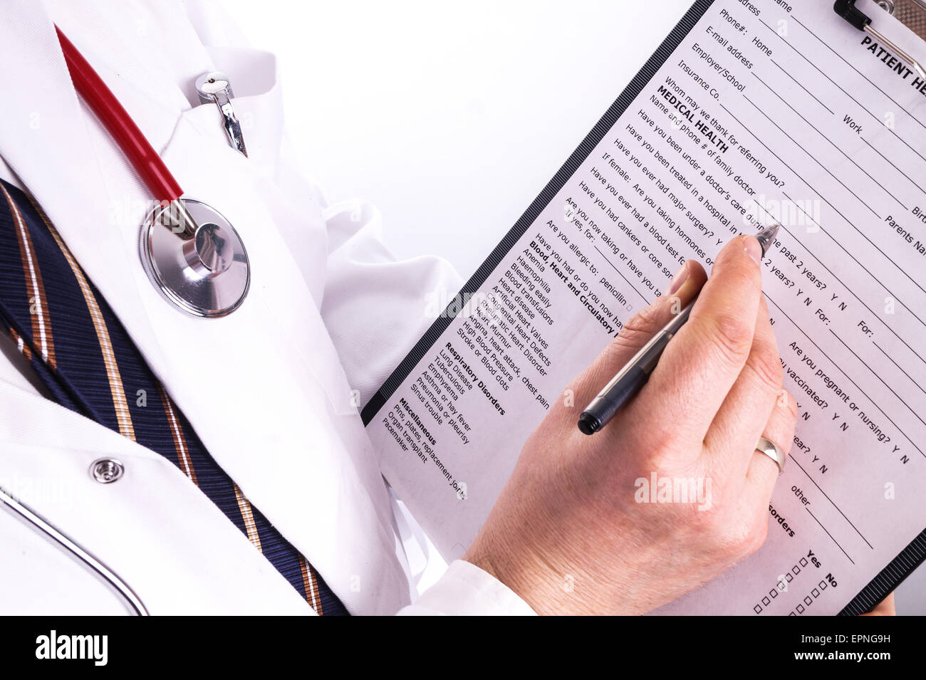 Male doctor fills patient registration form prior to admission and ...