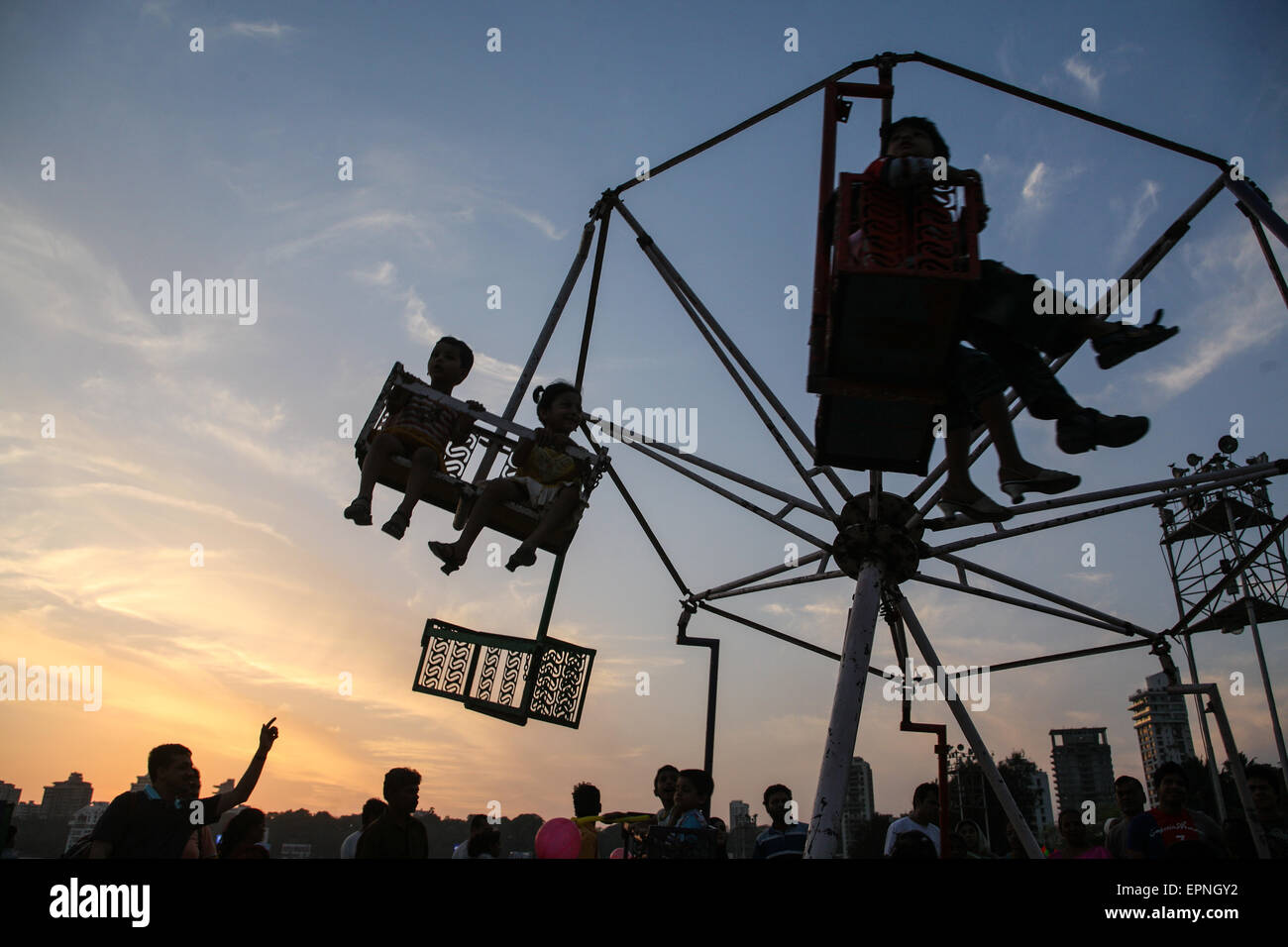 Silhouette children on fairground ride hi-res stock photography and ...