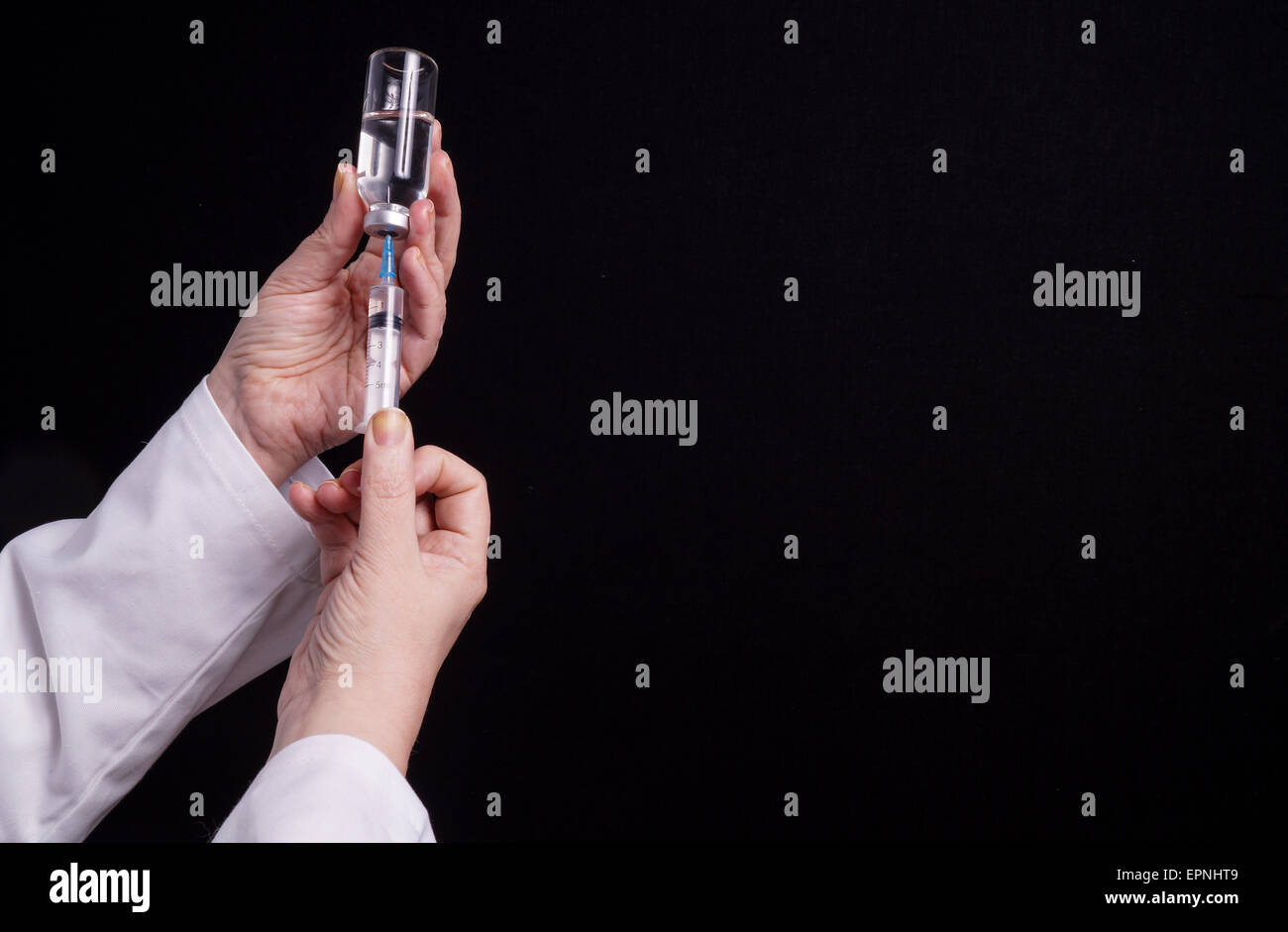 Filling of a syringe with medicine from vial. Medical person holding ...