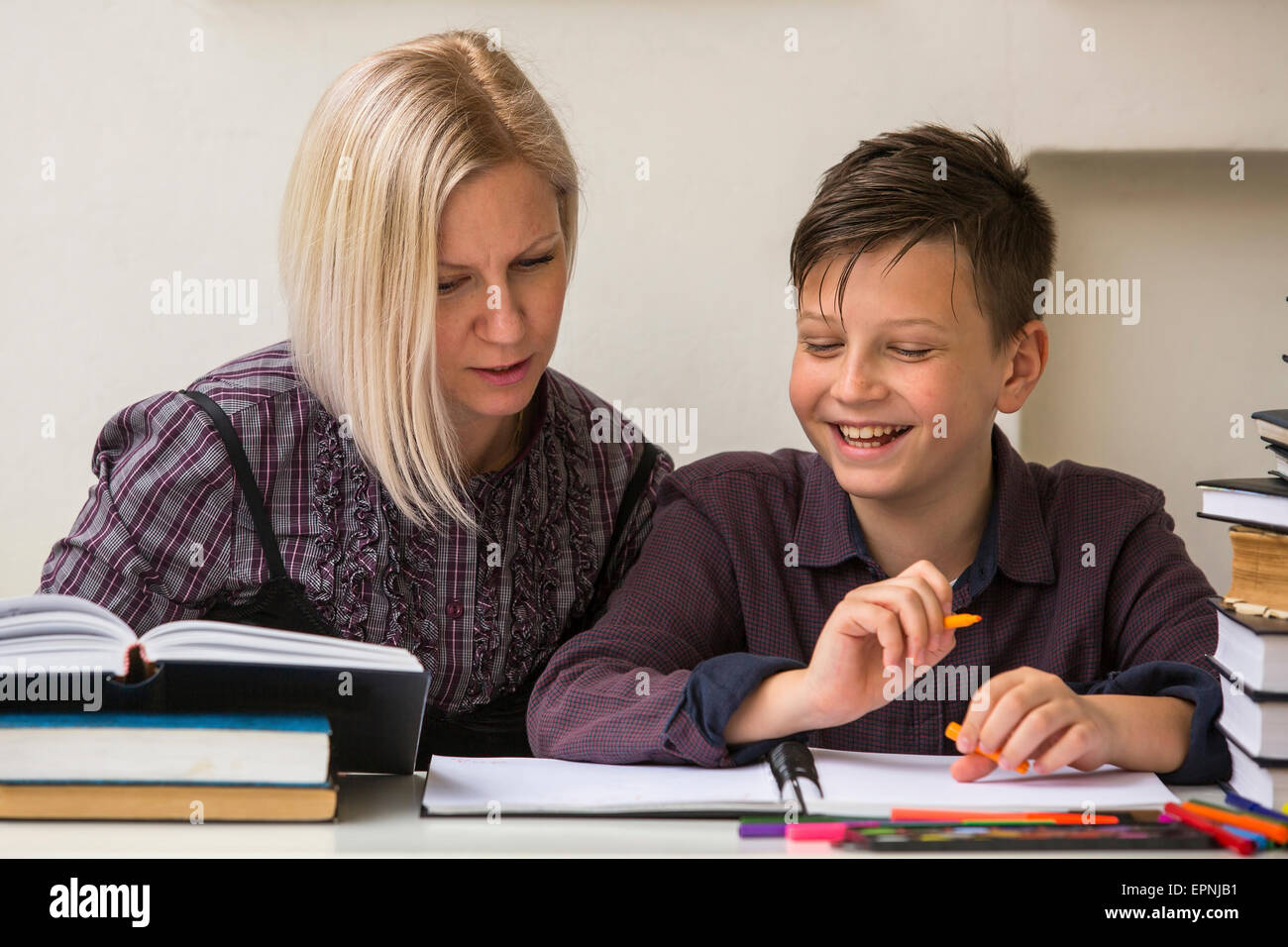 Young student engaged in the lessons with his teacher Stock Photo - Alamy