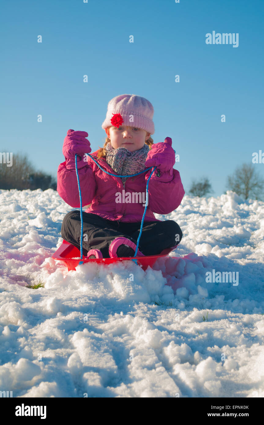 little girl sledging in the snow Stock Photo - Alamy