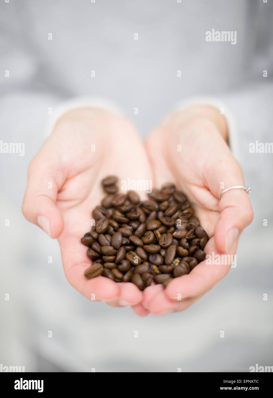 coffee beans in hand Stock Photo - Alamy