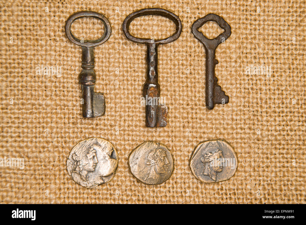 Some vintage keys from the locks and coins on old cloth Stock Photo - Alamy