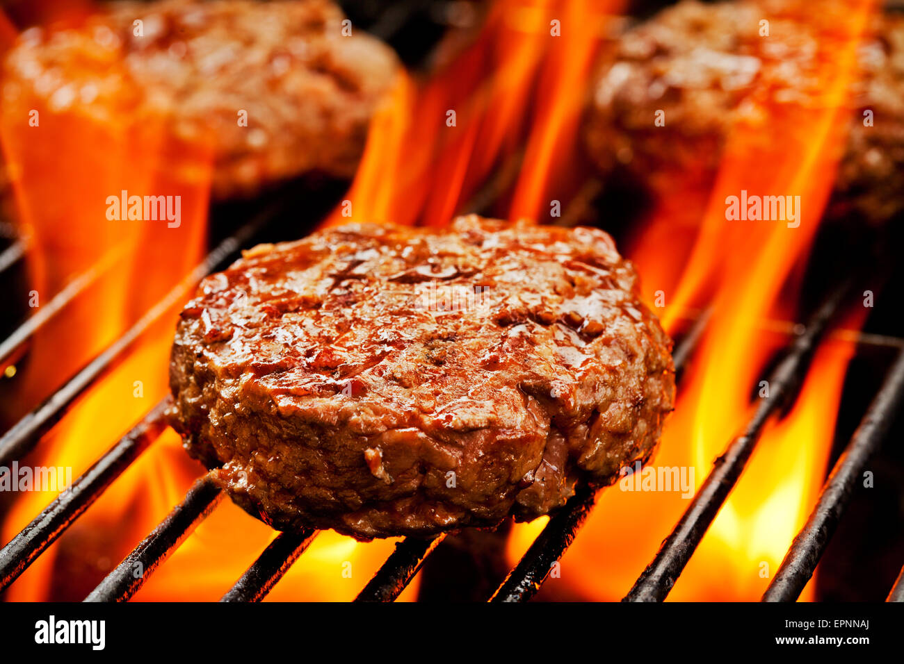 Close up of three burgers on the grill Stock Photo - Alamy
