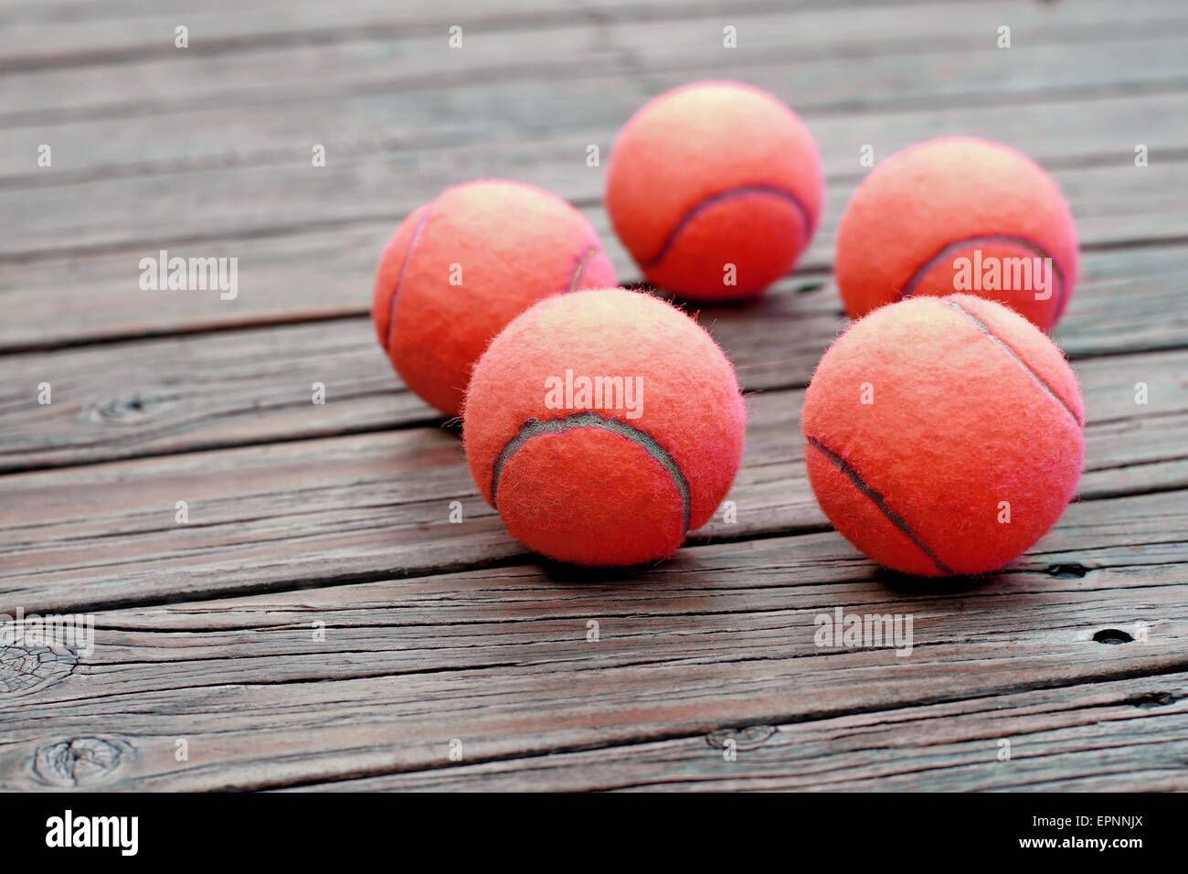 exotic red tennis ball on wooden background Stock Photo - Alamy