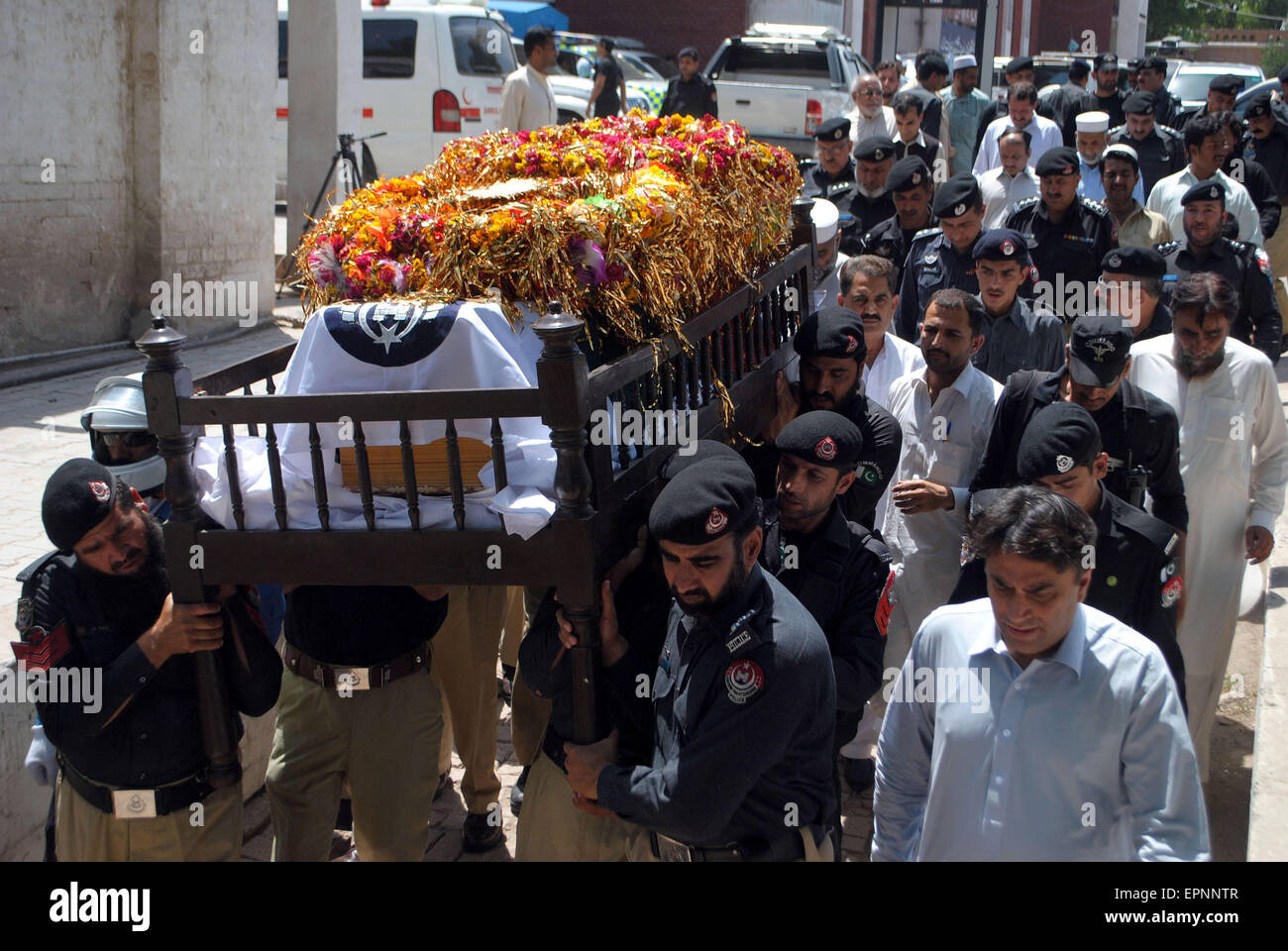 Peshawar. 20th May, 2015. People carry the coffin of a senior police ...