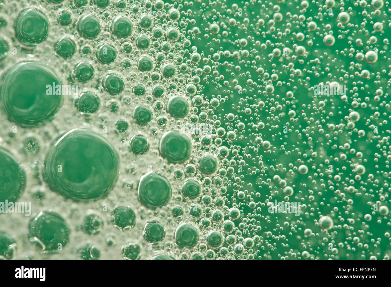 Macro Oxygen bubbles in water on a green background, concept such as ...