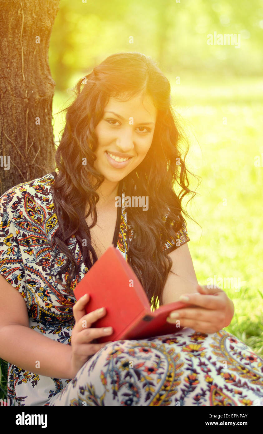 Portrait of beautiful girl reading book outdoors Stock Photo - Alamy