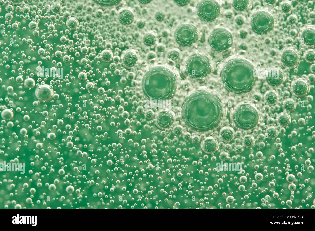 Macro Oxygen bubbles in water on a green background, concept such as ...