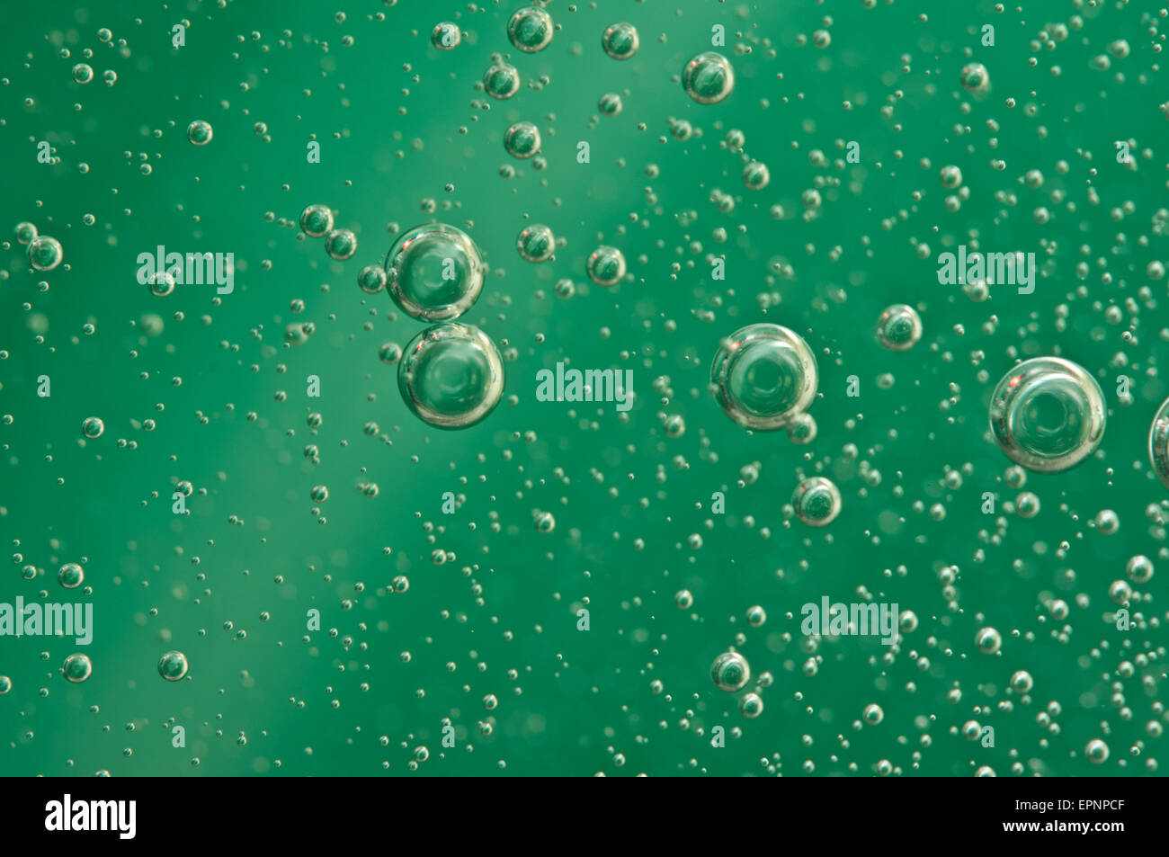 Macro Oxygen bubbles in water on a green background, concept such as ...