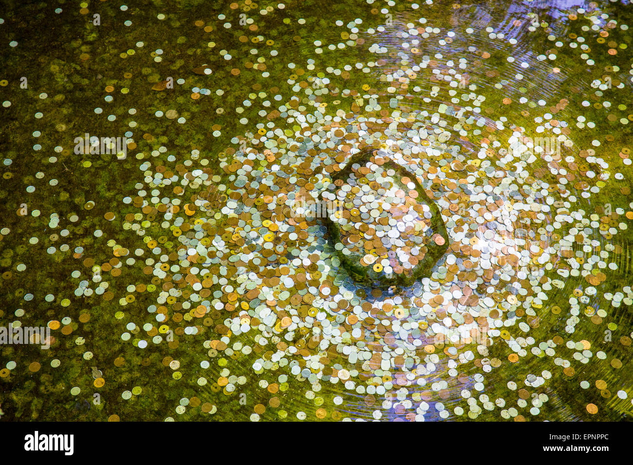 Coins in water for good luck and making a wish Stock Photo - Alamy