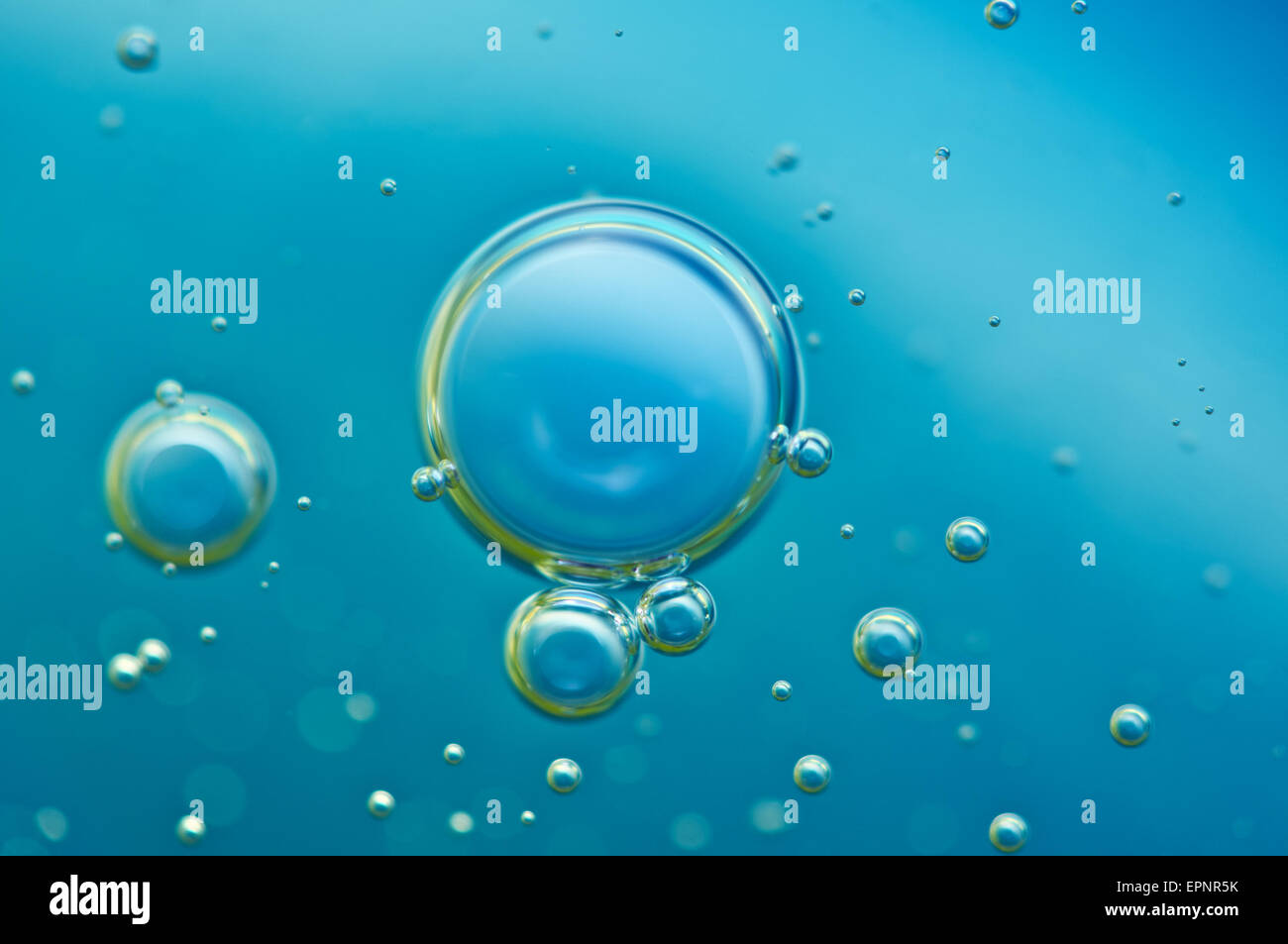 Macro Oxygen bubbles in water on a blue background, concept such as ...