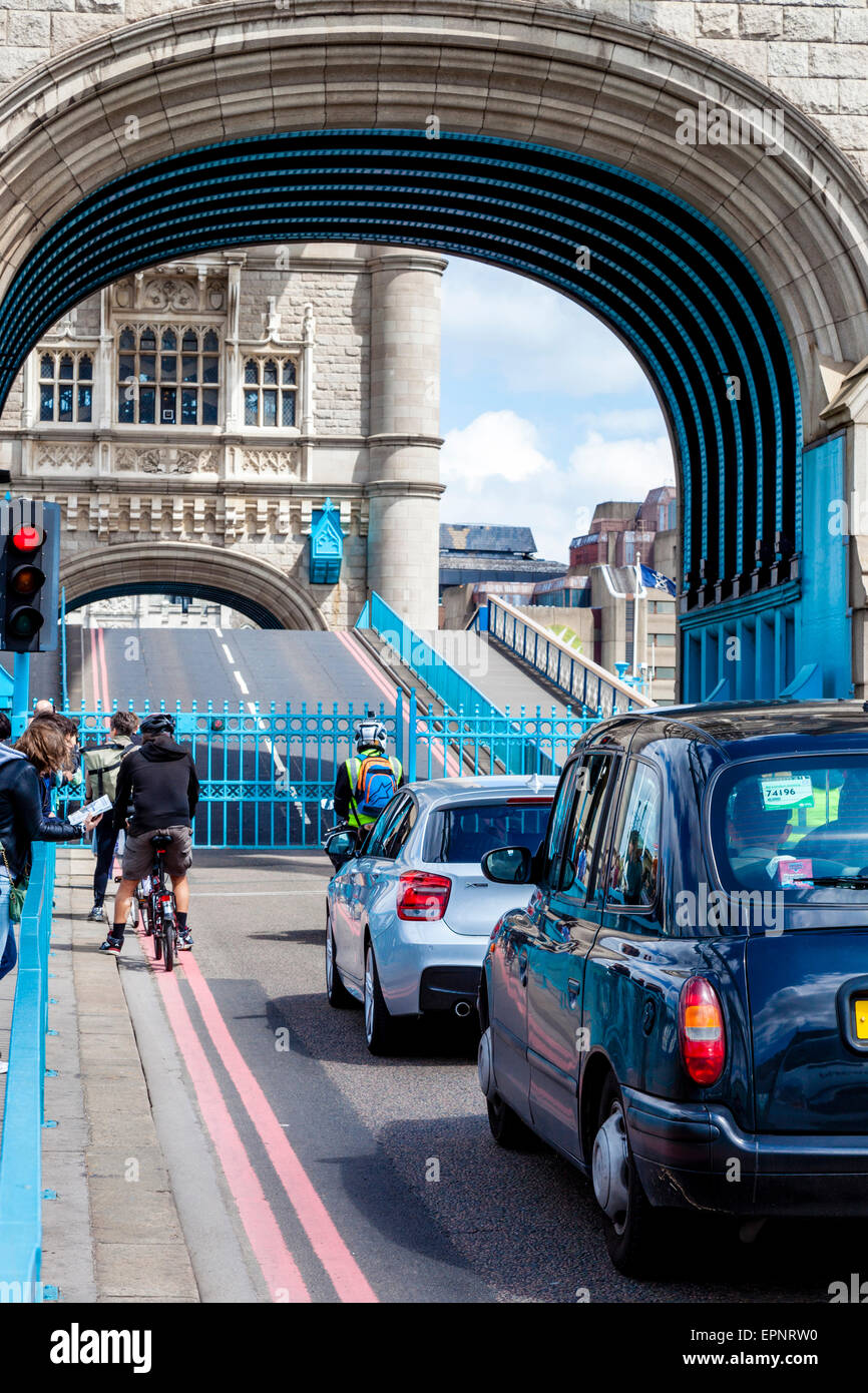 Traffic Waiting As Tower Bridge Is Raised, London, England Stock Photo ...