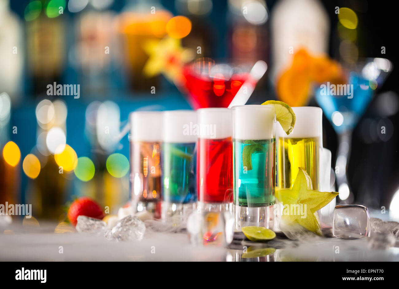 Variation of hard alcoholic shots with dry ice smoke effect, served on ...