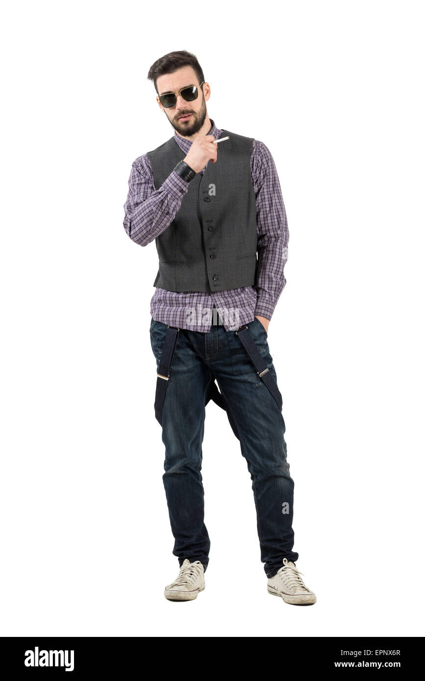 Serious young fashion male model smoking cigarette. Full body length ...