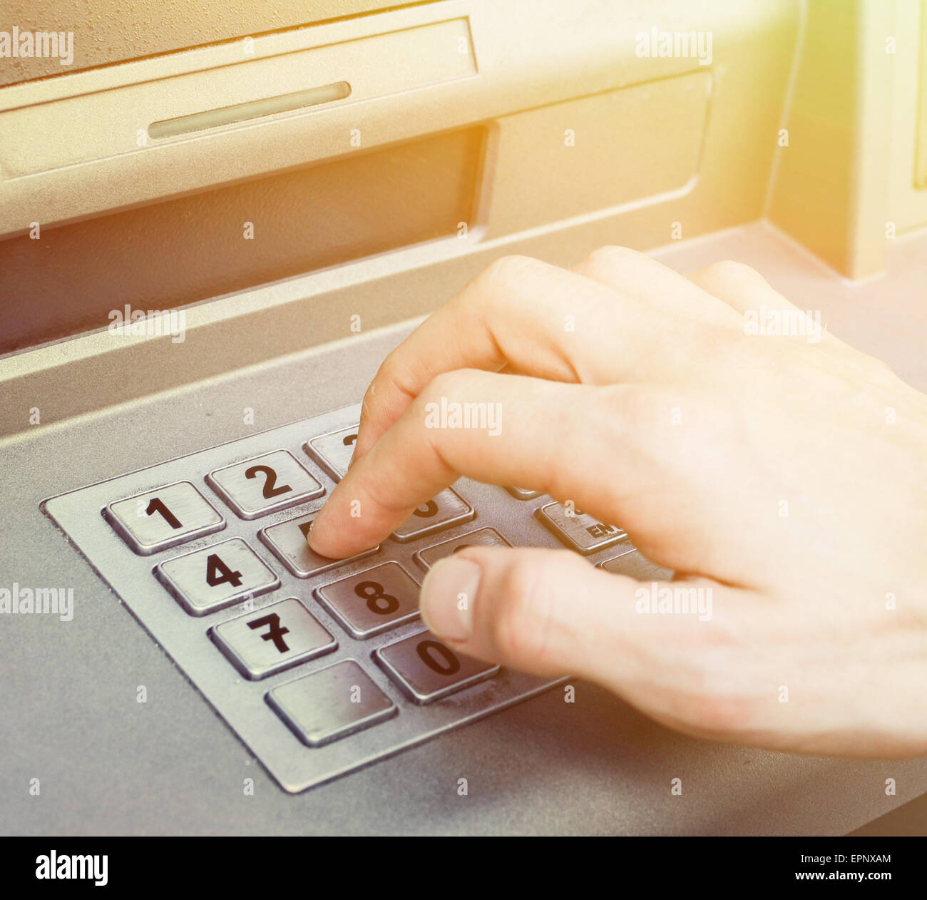 Hand entering PIN numbers on ATM bank machine Stock Photo - Alamy