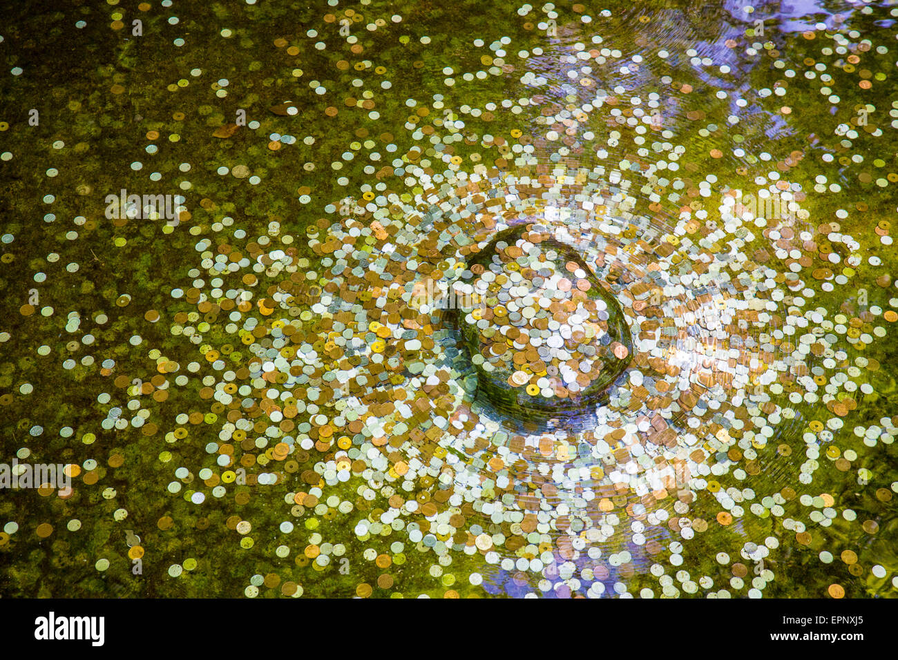 Coins in water for good luck and making a wish Stock Photo - Alamy
