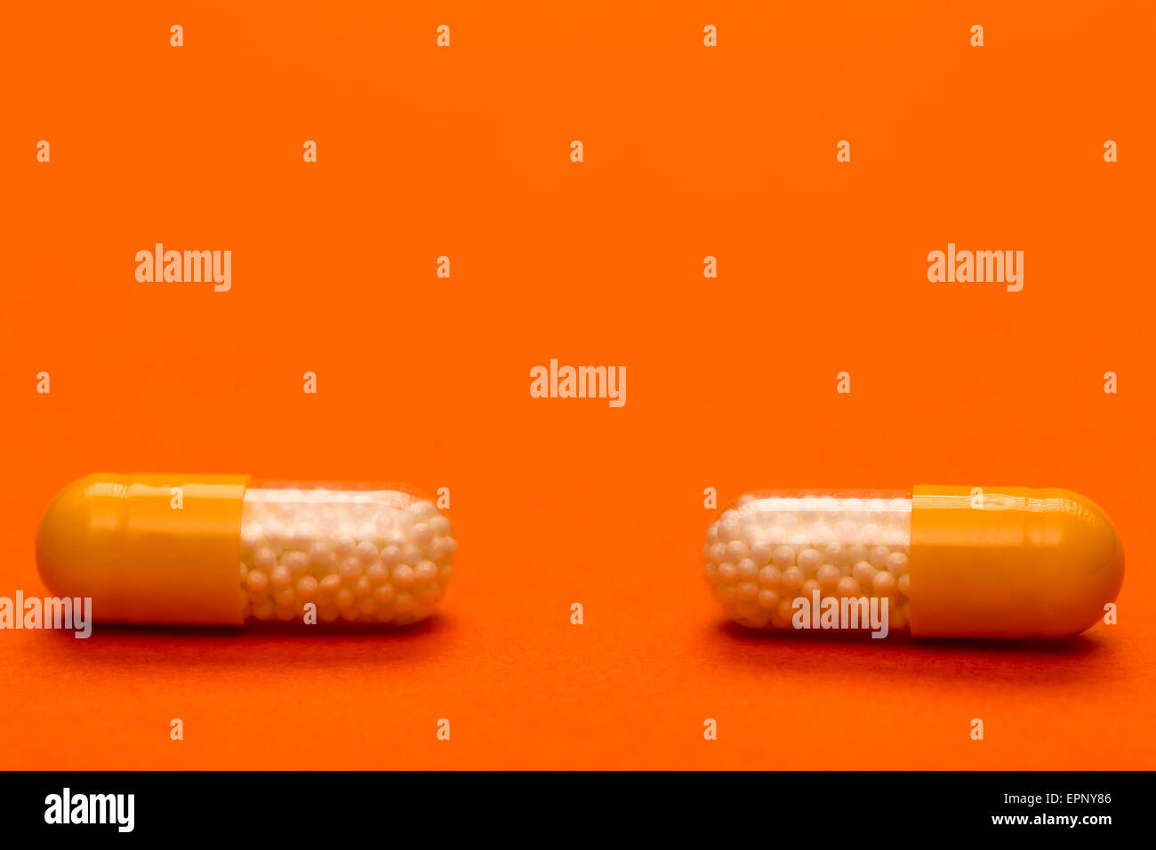 Color medical capsules text space on pink background Stock Photo - Alamy