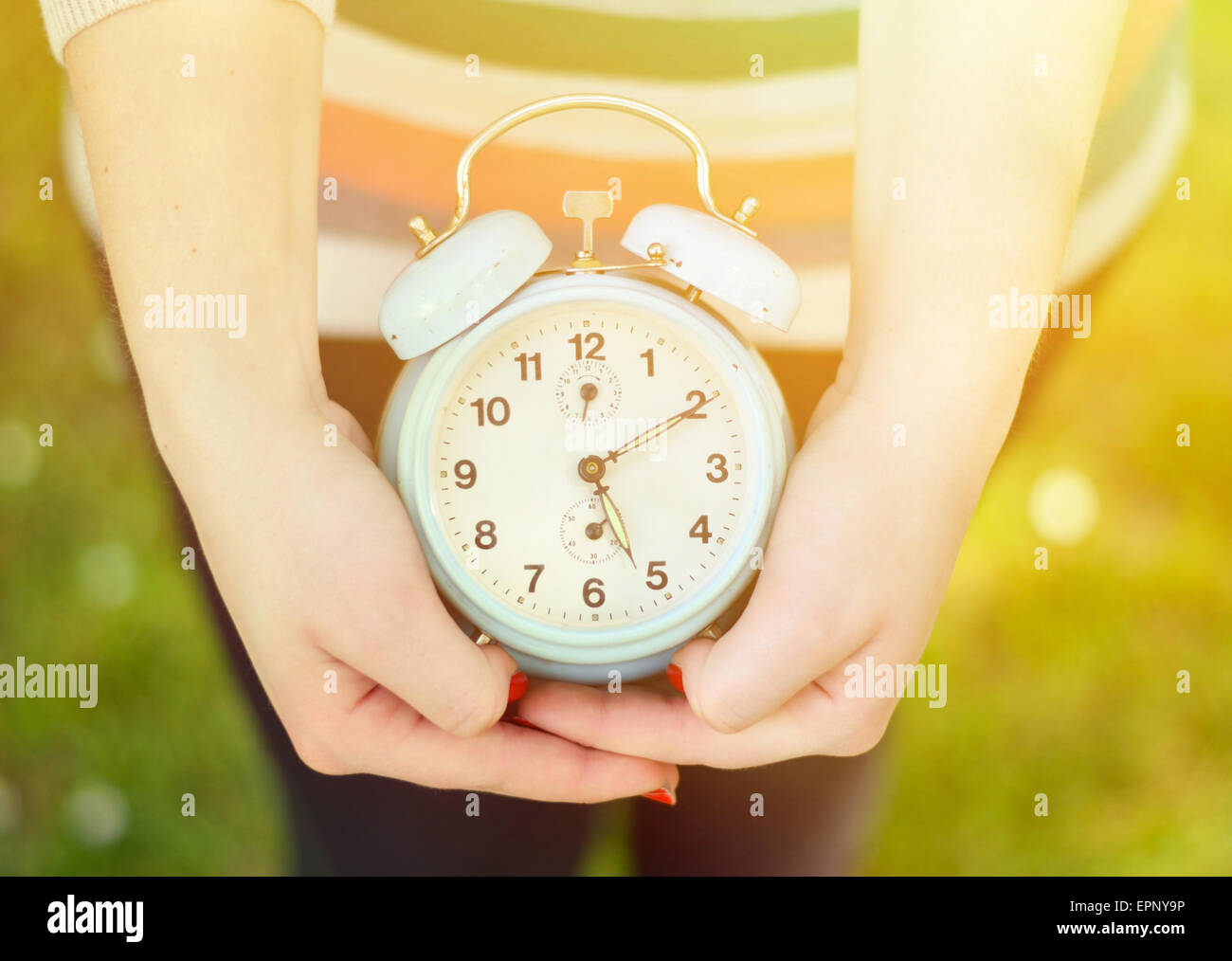 Hands holding old clock Stock Photo - Alamy