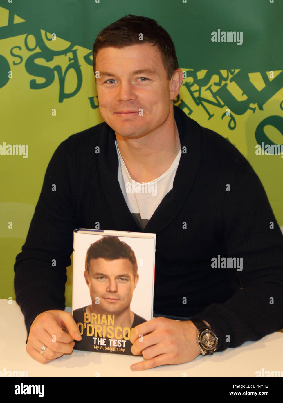 Retired Irish rugby player Brian O'Driscoll signs copies of his ...