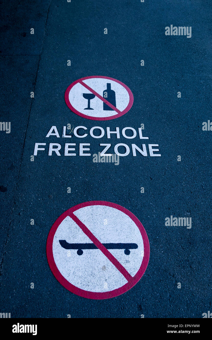 Alcohol free zone and no skatboarding area symbols marked on the tarmac ...