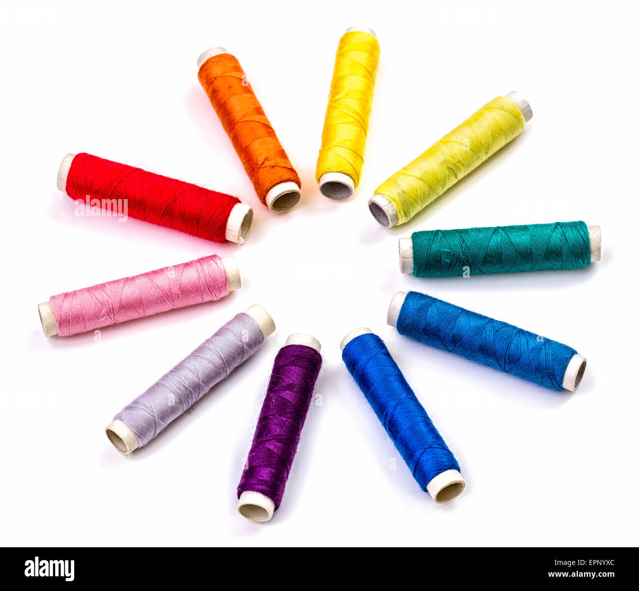 Colorful thread rolls in a circle on a white background Stock Photo - Alamy