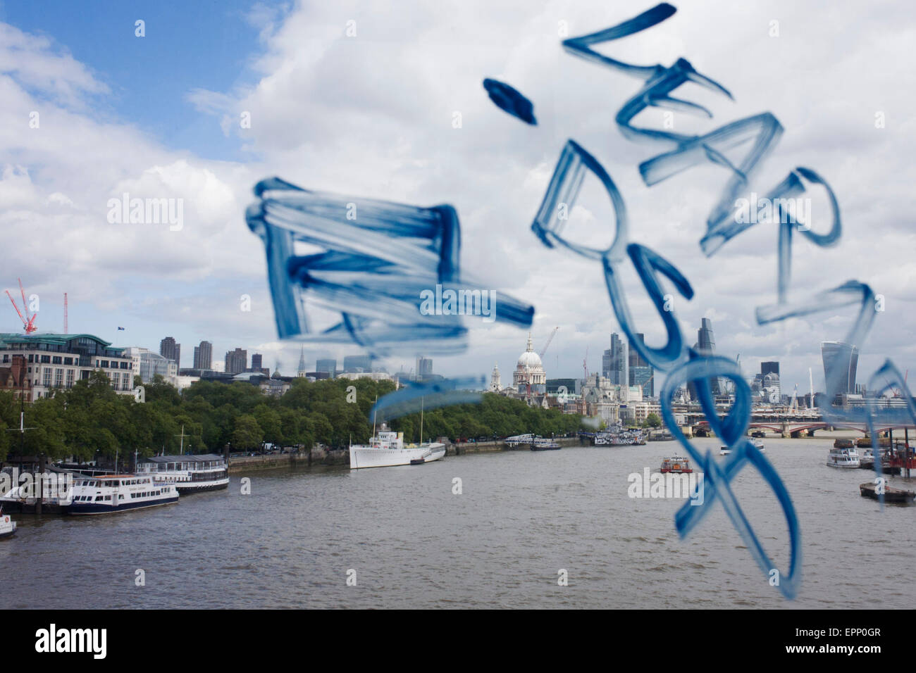 City of London seen through blue graffiti on a bus while crossing ...
