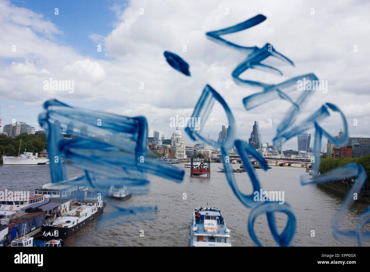 City of London seen through blue graffiti on a bus while crossing ...