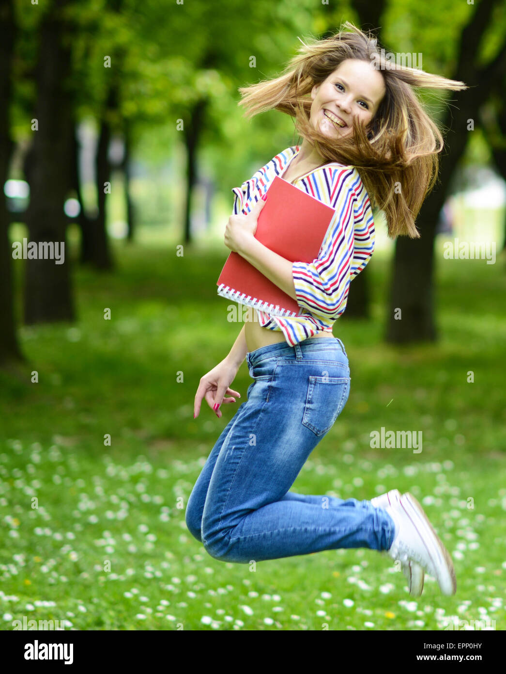 Happy student girl jumping for joy after passed exam Stock Photo - Alamy