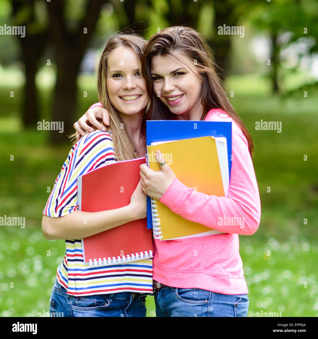 Happy students in summer park Stock Photo - Alamy