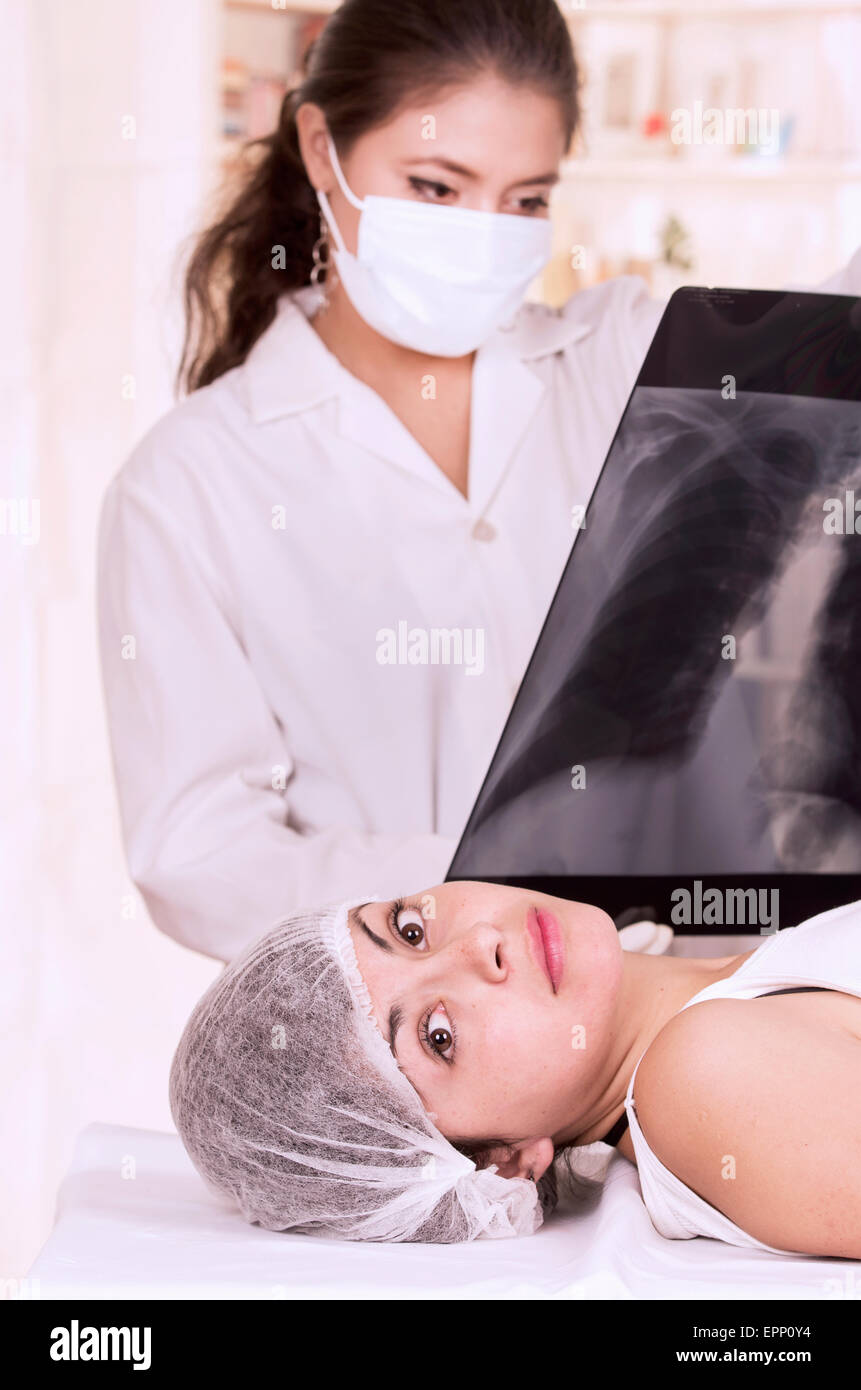 Female doctor checking xray of a young girl patient Stock Photo - Alamy