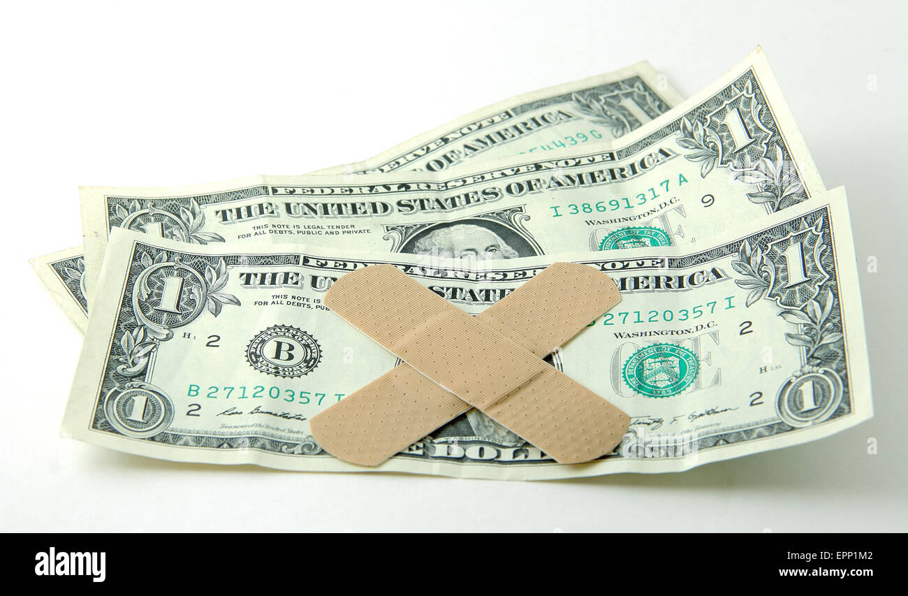 Dollar bills with band-aids = economic hardship Stock Photo - Alamy