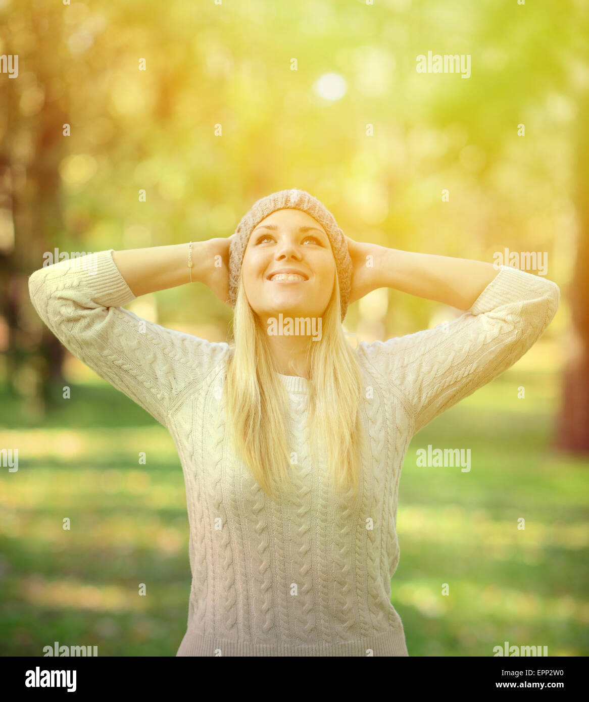 Happy woman looking up in the sky in forest Stock Photo - Alamy