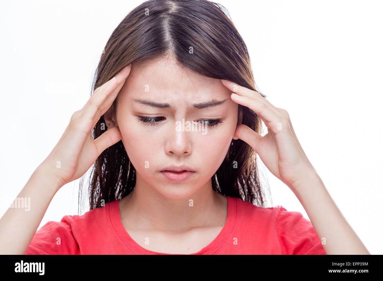 Chinese woman with headache, putting hands on temples Stock Photo - Alamy